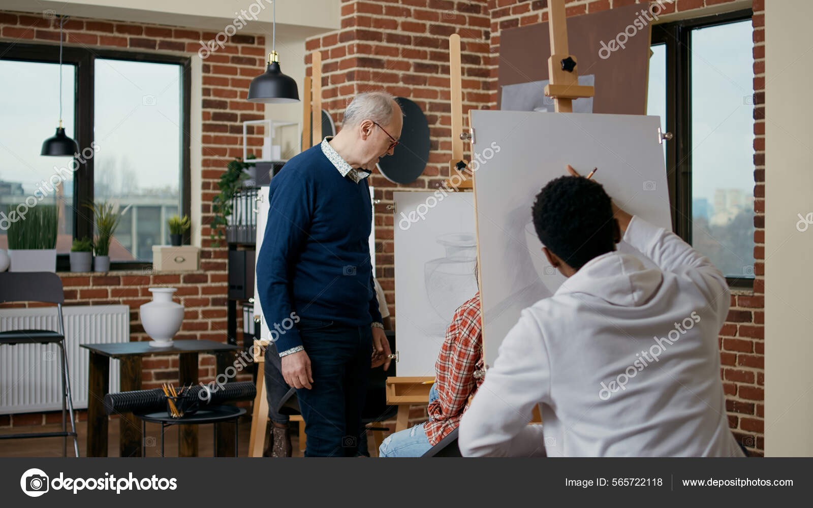 Senior teacher analyzing drawing technique of student in art class ...