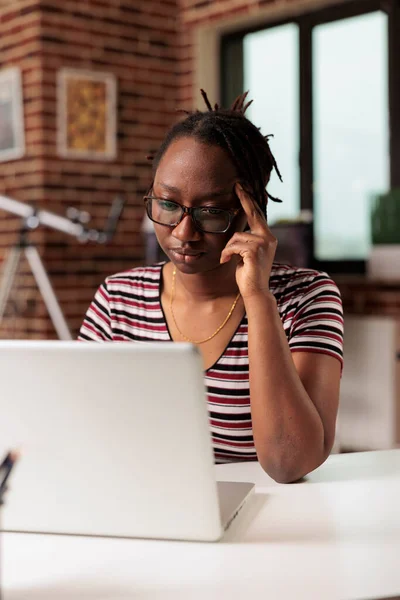 Tired woman having migraine, thoughtful employee working on laptop ...