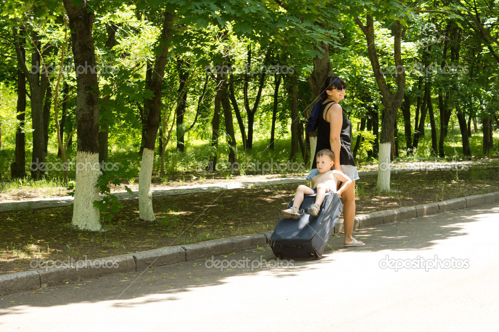 Boy being carried on top of a trolley travel bag Stock Photo by ...