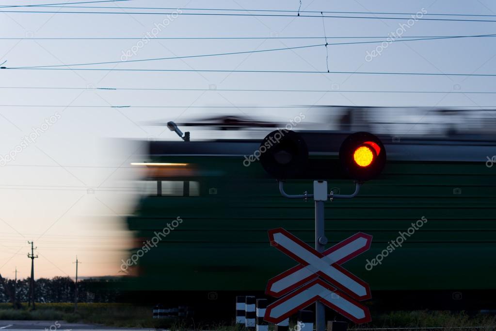Speeding train passing a level crossing Stock Photo by ©Vaicheslav 28743413