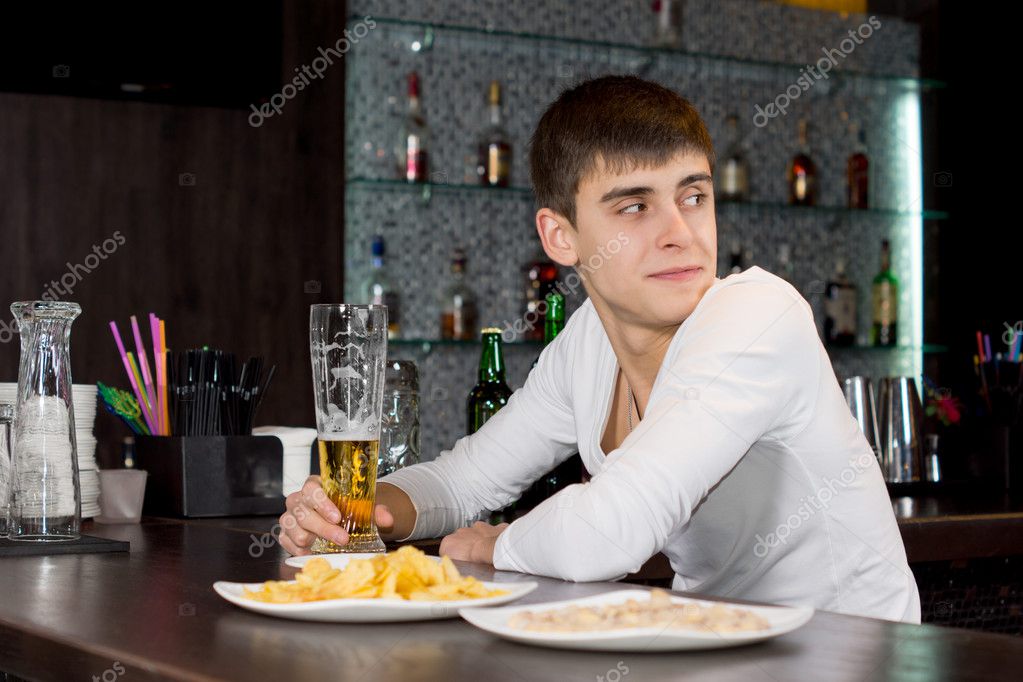 Young man sitting at a bar counter waiting — Stock Photo © Vaicheslav ...