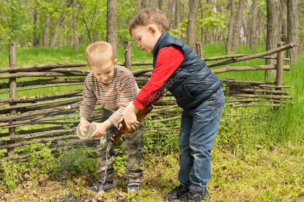 Two responsible little boys putting out a fire Stock Photo by ...