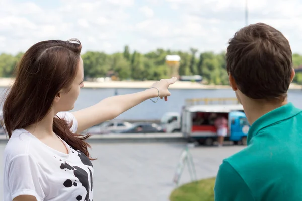 Young woman showing the direction to a tourist - Stock Image - Everypixel