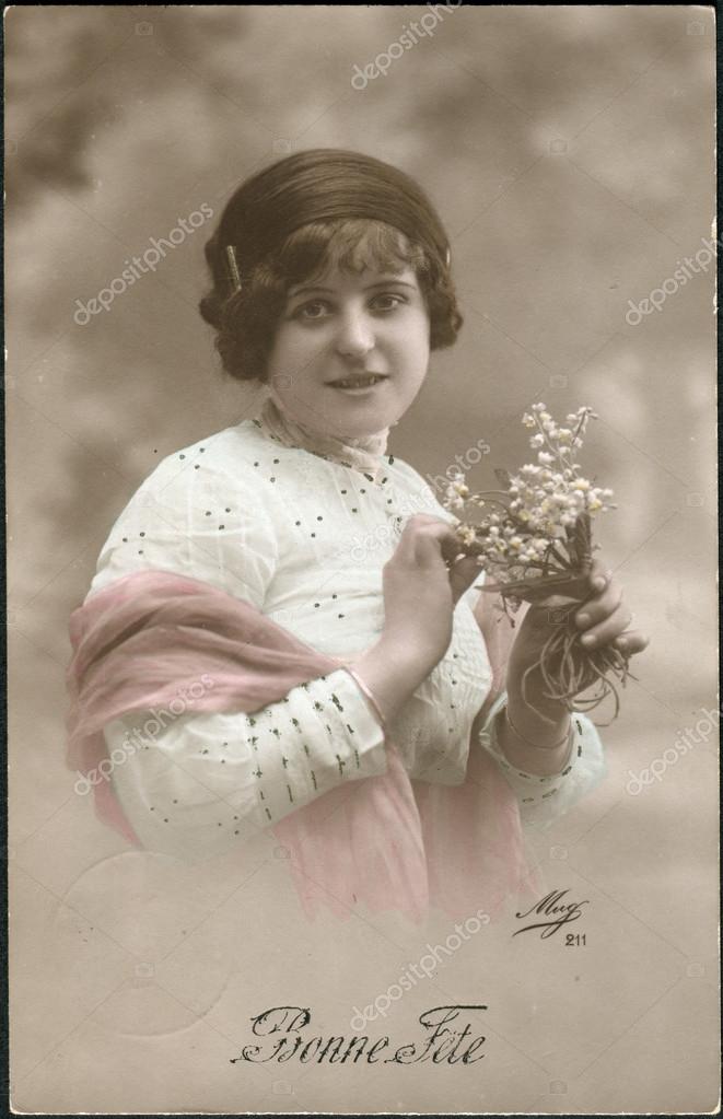 Old Swiss postcard 1917. Shows a girl with flowers. The inscription in ...