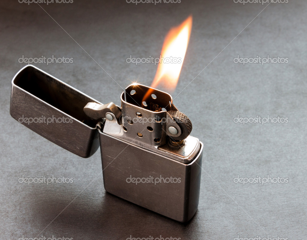 Silver metal lighter with flame. Stock Photo by ©eevl 19558293