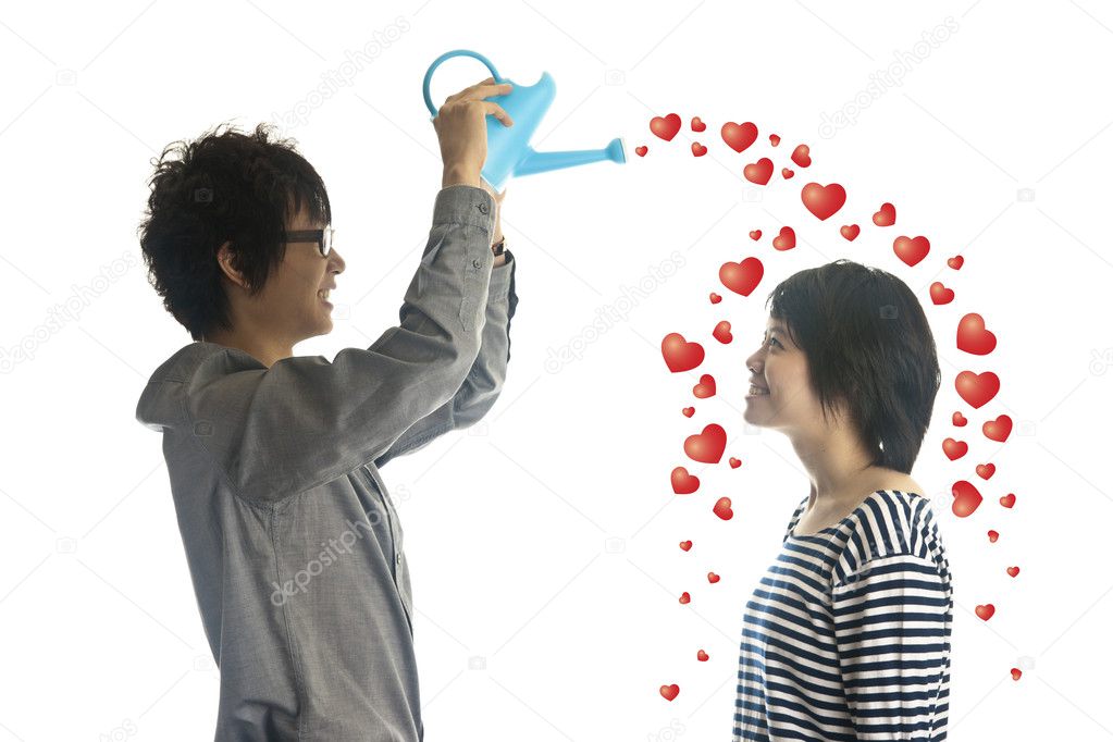 Romantic young couple pouring hearts from watering can — Stock Photo ...