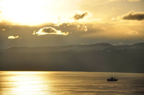 Liquid Gold Holiday boat. Sailing boat surrounded by sun glitters sea on beautiful sunset ...
