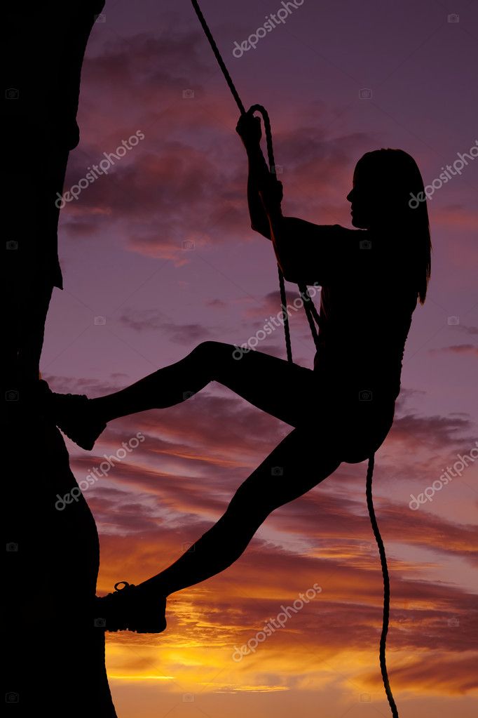 Woman silhouette climbing rock Stock Photo by ©alanpoulson 13682567