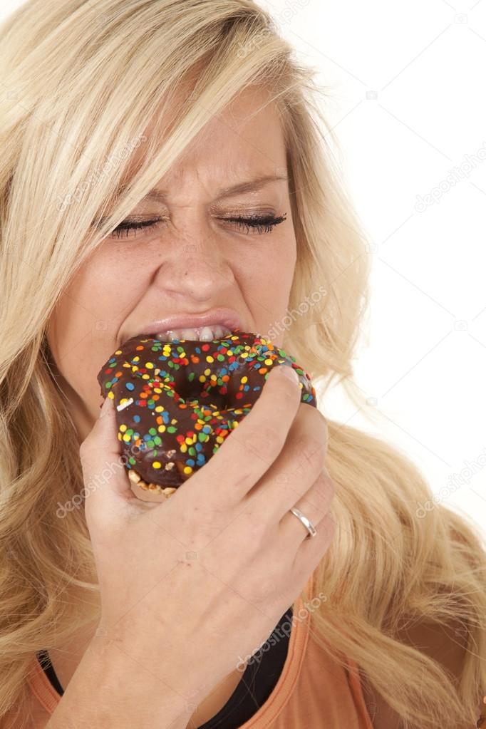 Woman biting into a donut Stock Photo by ©alanpoulson 29124681