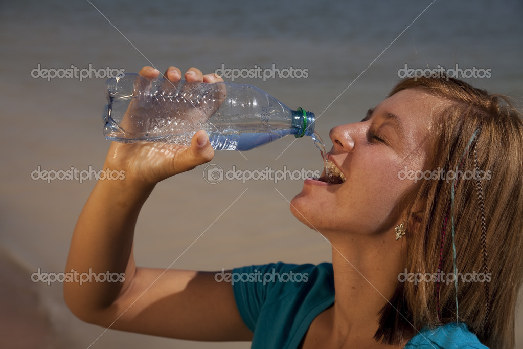 Woman refreshing her body by getting a drink from a bottle. — Stock ...