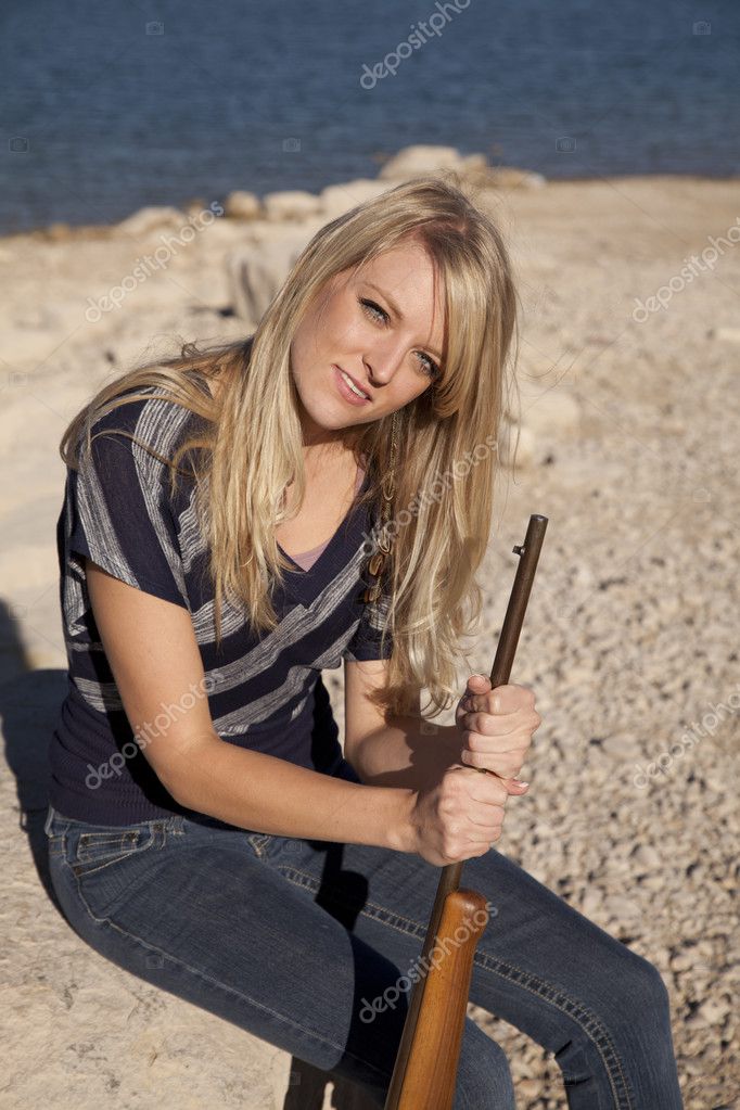 Woman lake rifle sit Stock Photo by ©alanpoulson 29579547