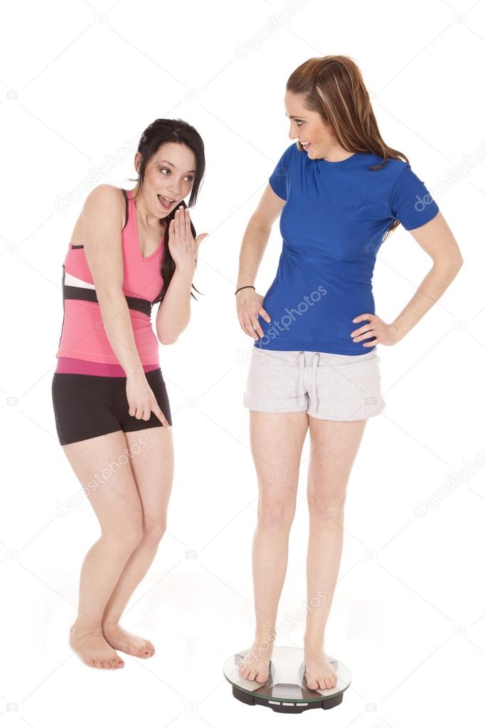 Woman laughing at another on scales — Stock Photo © alanpoulson #29580191