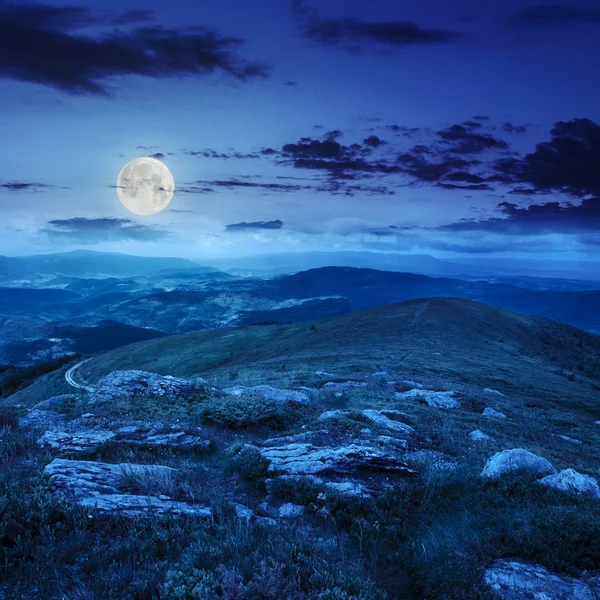 Light on stone mountain slope at night - Stock Image - Everypixel