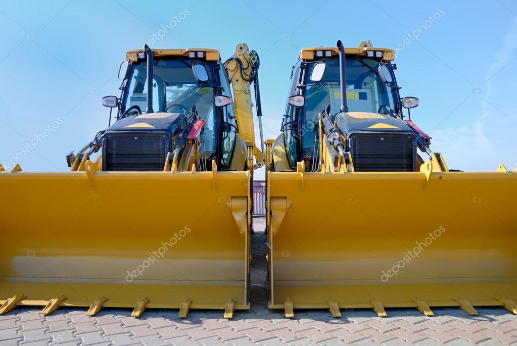 Two new bulldozers on a showcase — Stock Photo © soleg #12116090