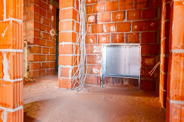 Bundle of various cables are hanging from ceiling, new empty ...