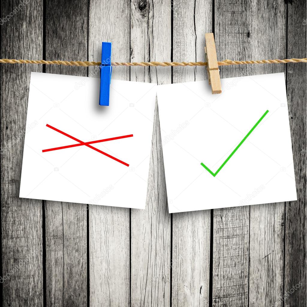 Tick and cross on note paper attach to rope with clothes pins o — Stock ...