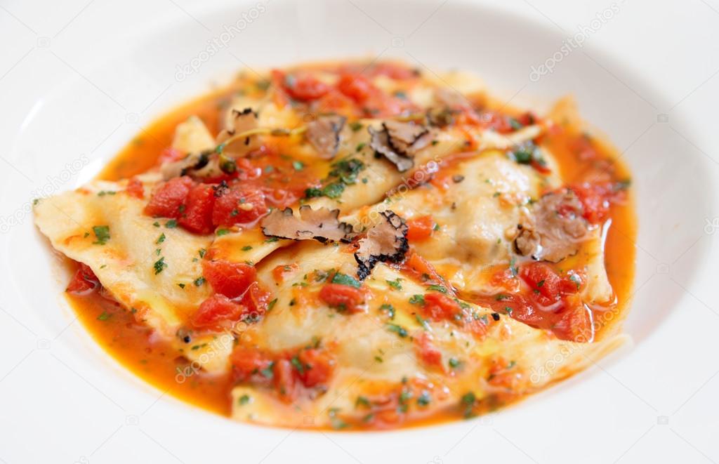 Tasty ravioli with tomato sauce and black truffle Stock Photo by ...