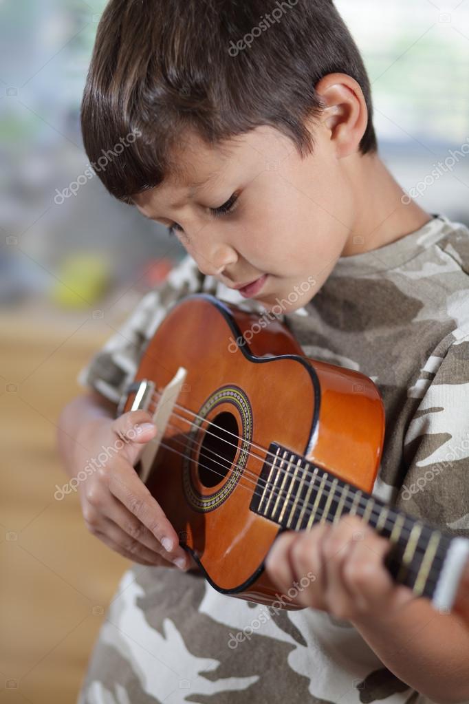 Boy playing guitar Stock Photo by ©dmediapro 12170248