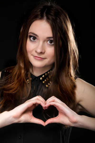 Girl making heart symbol Stock Photo by ©Voyagerix 66102357