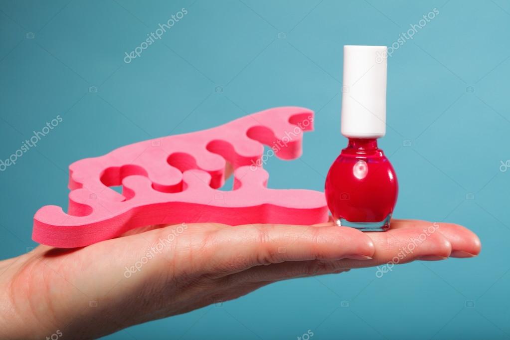 Foot pedicure red nail polish and toe separators — Stock Photo ...