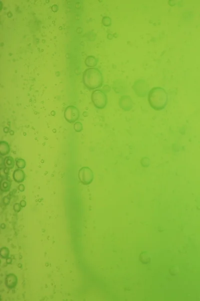 Soap bubbles green liquid background — Stock Photo © Voyagerix #31863887