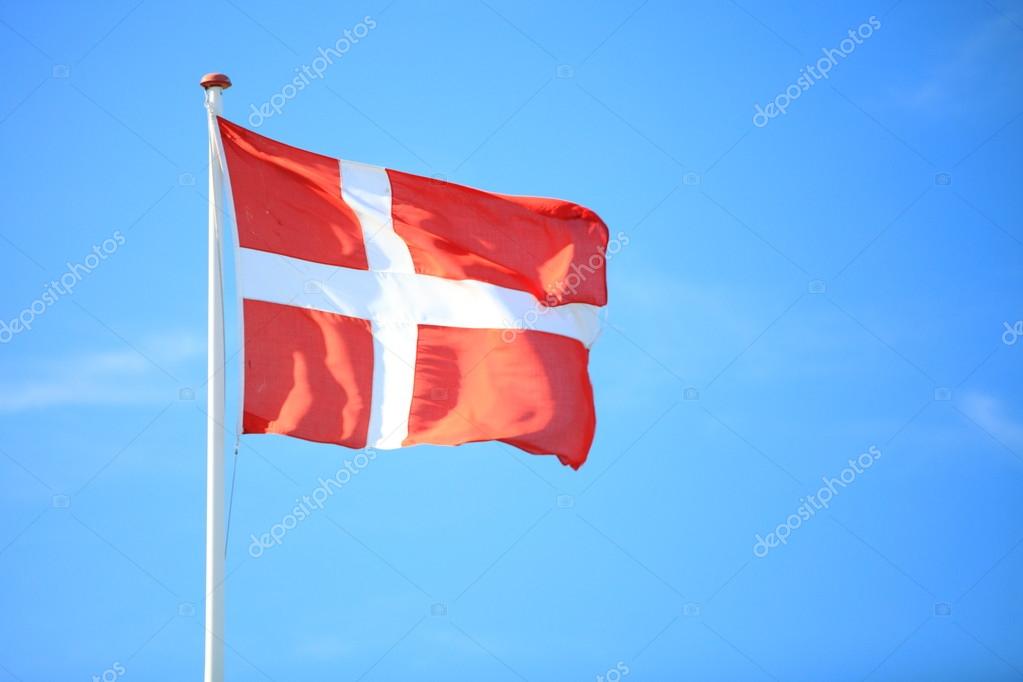 Danish flag with blue sky on background Stock Photo by ©Voyagerix 33671439