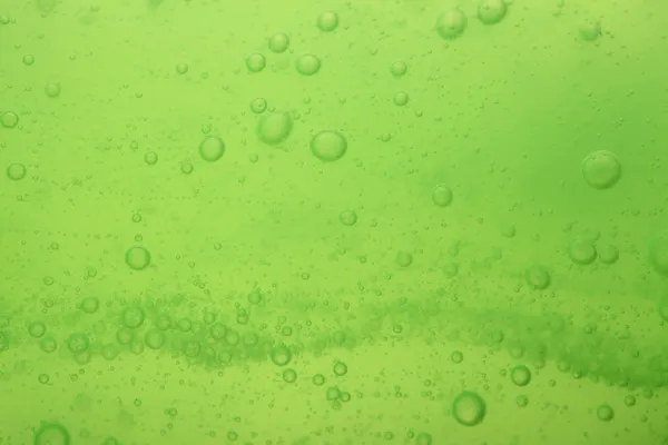 Soap bubbles green liquid background Stock Photo by ©Voyagerix 31863887