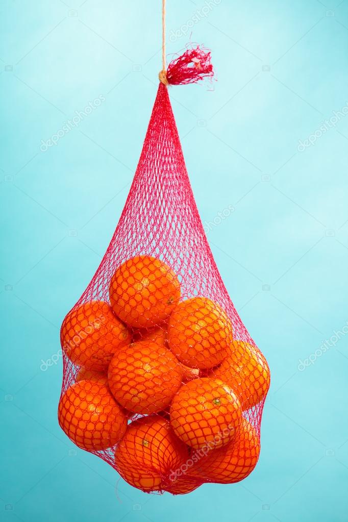 Fresh oranges fruits in mesh from supermarket — Stock Photo © Voyagerix ...