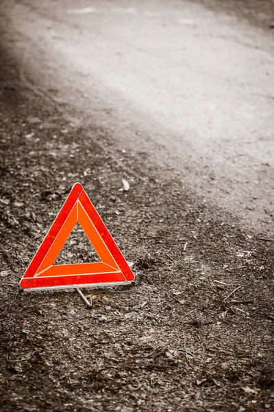 Red warning triangle sign on road — Stock Photo © Voyagerix #48822503