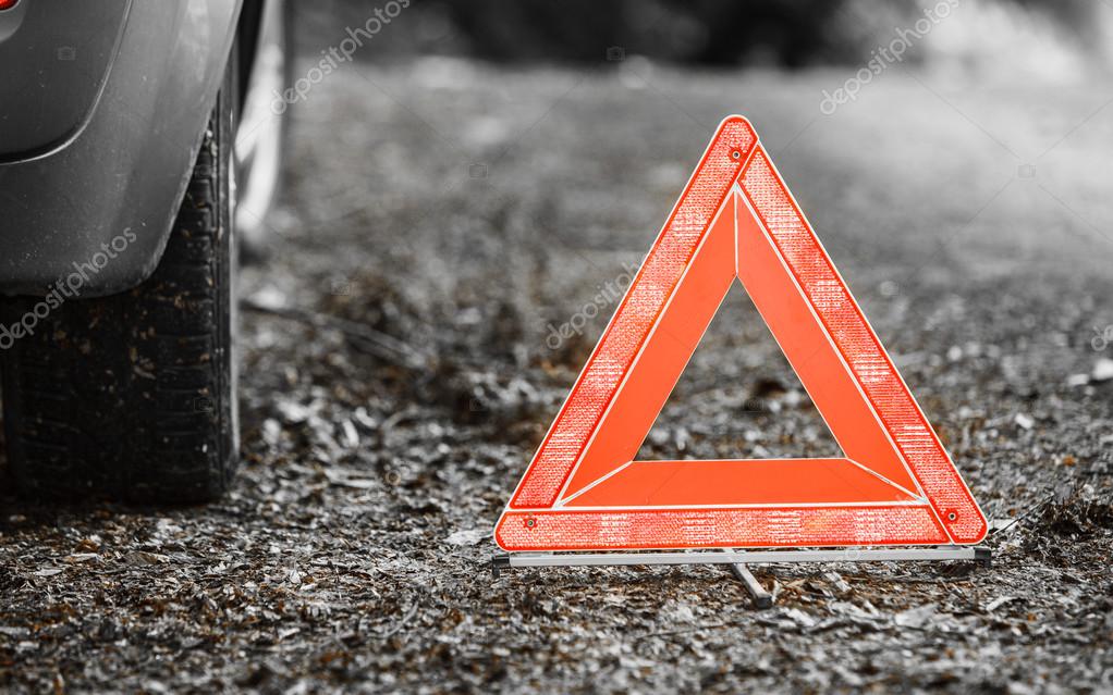 Red warning triangle sign on road — Stock Photo © Voyagerix #48822503
