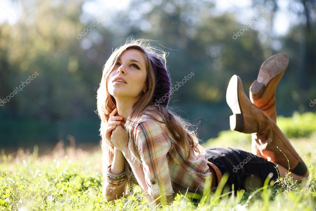 Beautiful Young Woman lying on grass — Stock Photo © savageultra #20405843