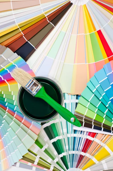 Samples with different shades of blue and can of blue paint with paint ...