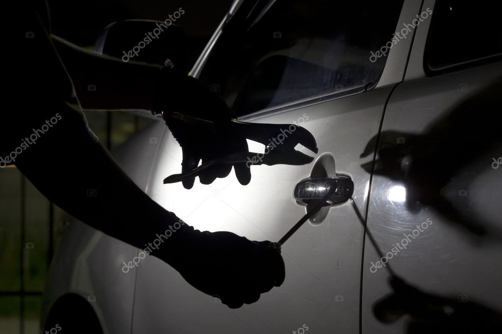 Car thief using a tool to break into a car. Stock Photo by ©toa55 25903203