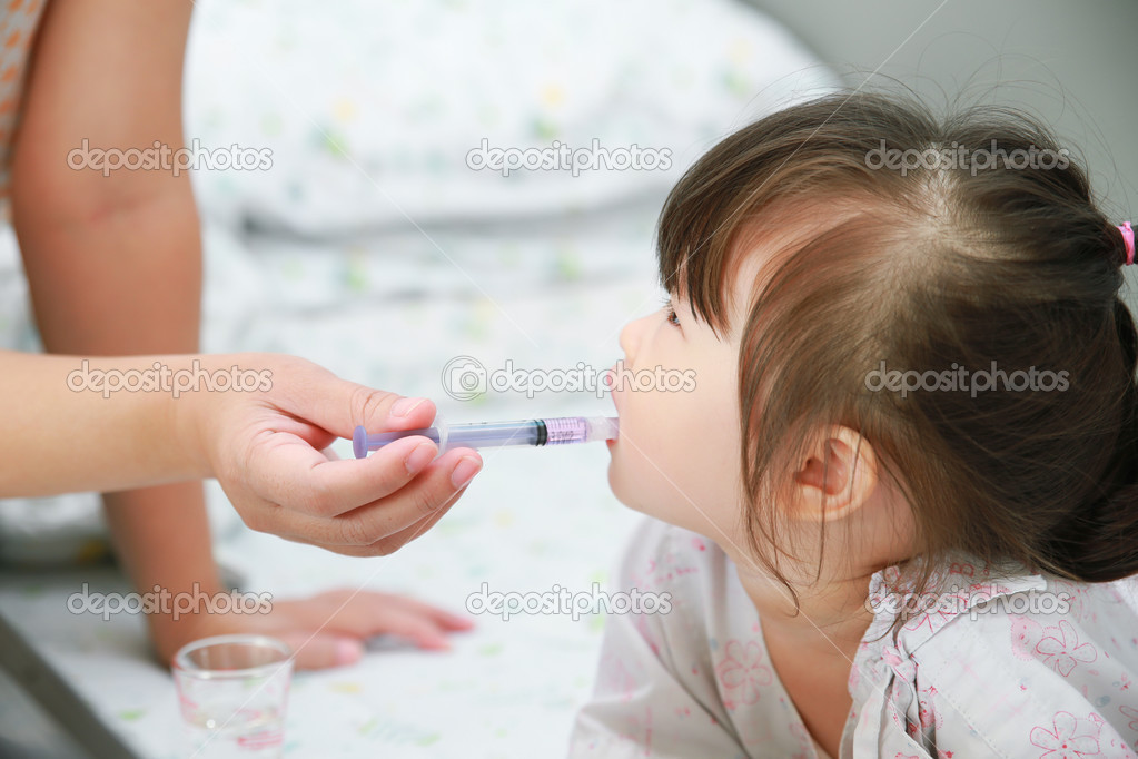 Mother giving her daughter liquid syrup Stock Photo by ©actionbleem ...