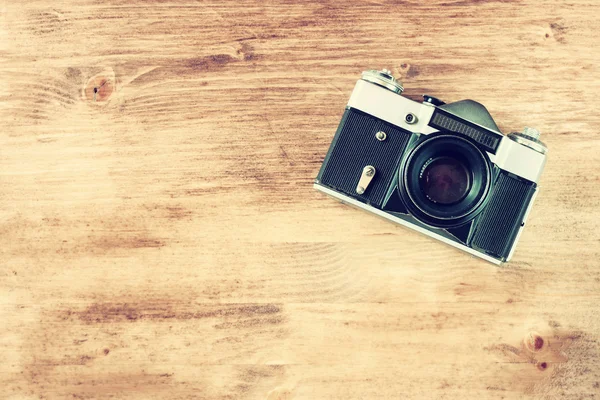 Top view of old vintage camera and pictures over wooden brown ...