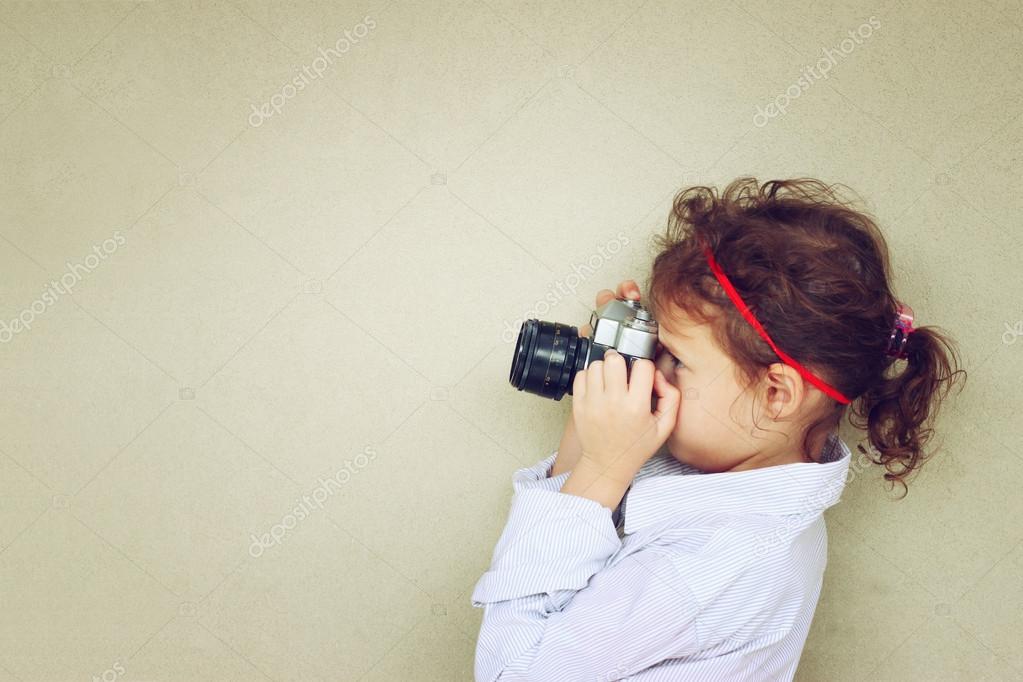Concept of cute kid looking through vintage camera — Stock Photo ...