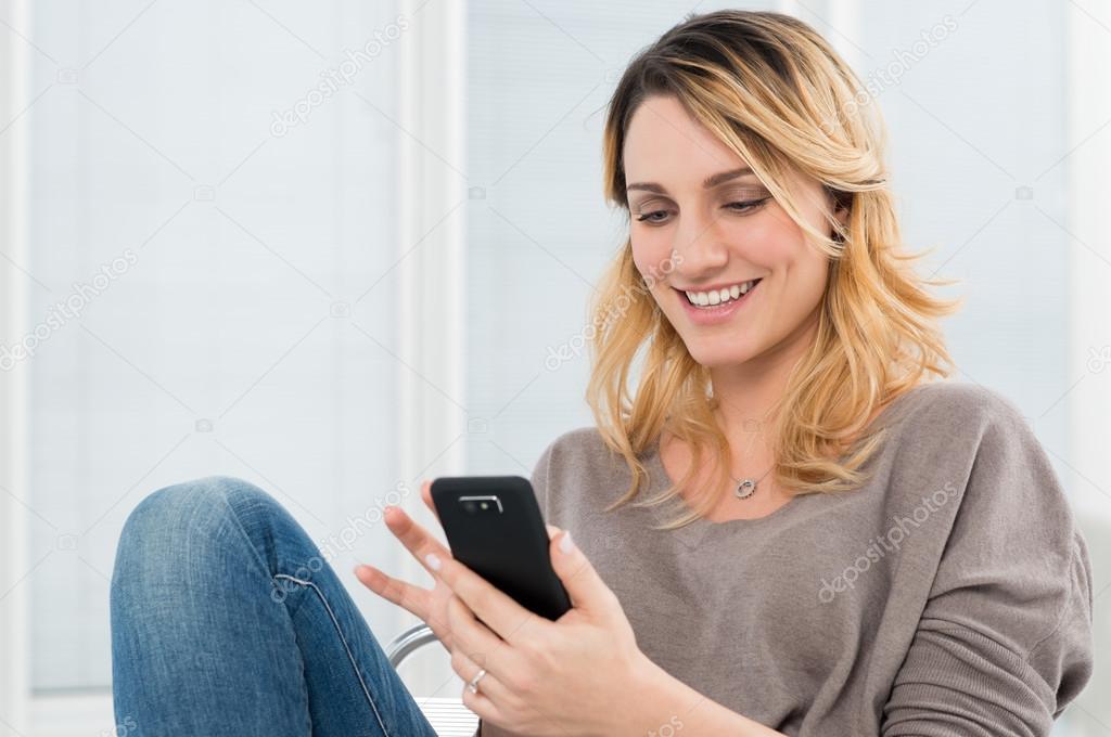 Smiling Woman Playing With Cellphone Stock Photo by ©ridofranz 44860953