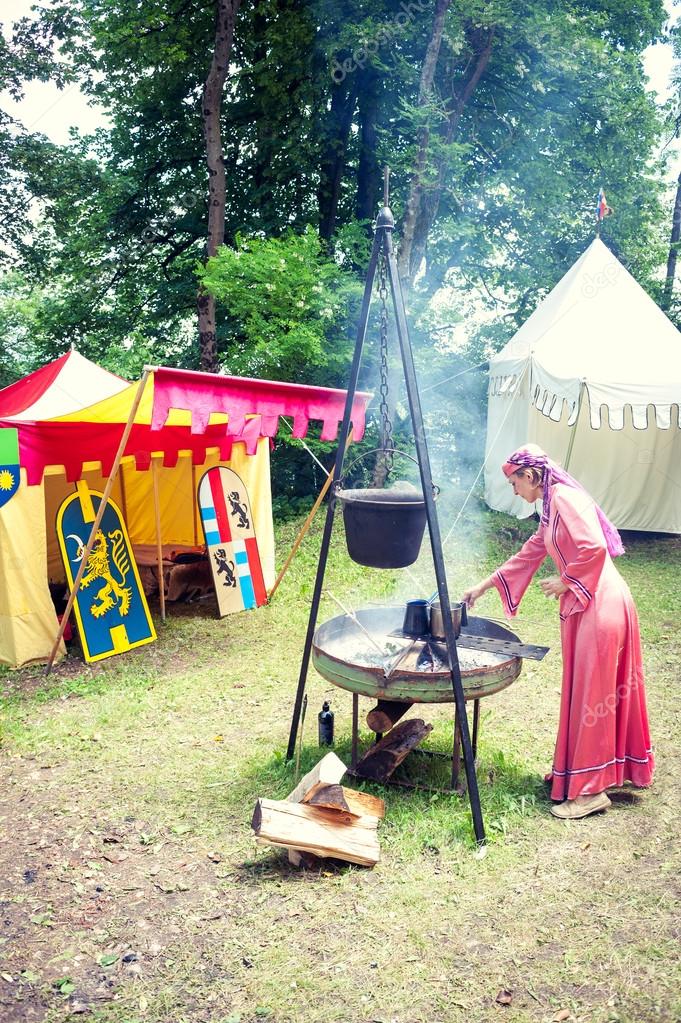 Medieval fireplace and lady dressed according to this time – Stock ...