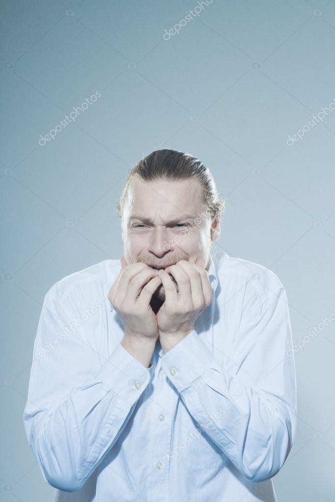 Anxious man chewing on fingernails Stock Photo by ©piolka 29003177