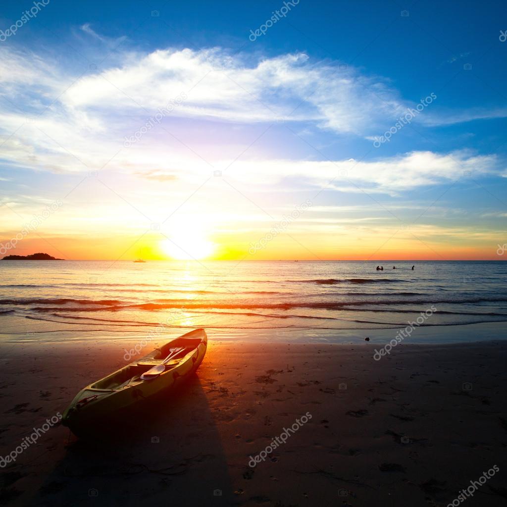 Kayak on the beach at sunset. — Stock Photo © dimaberkut #18021877