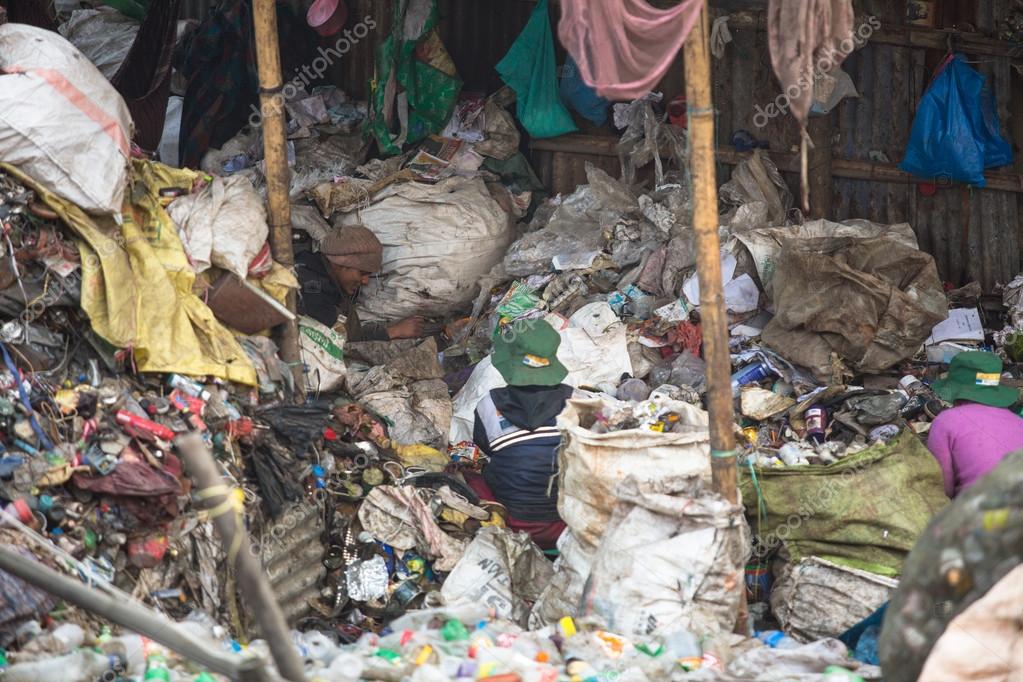 Unidentified people from poorer areas working in sorting of plastic on ...
