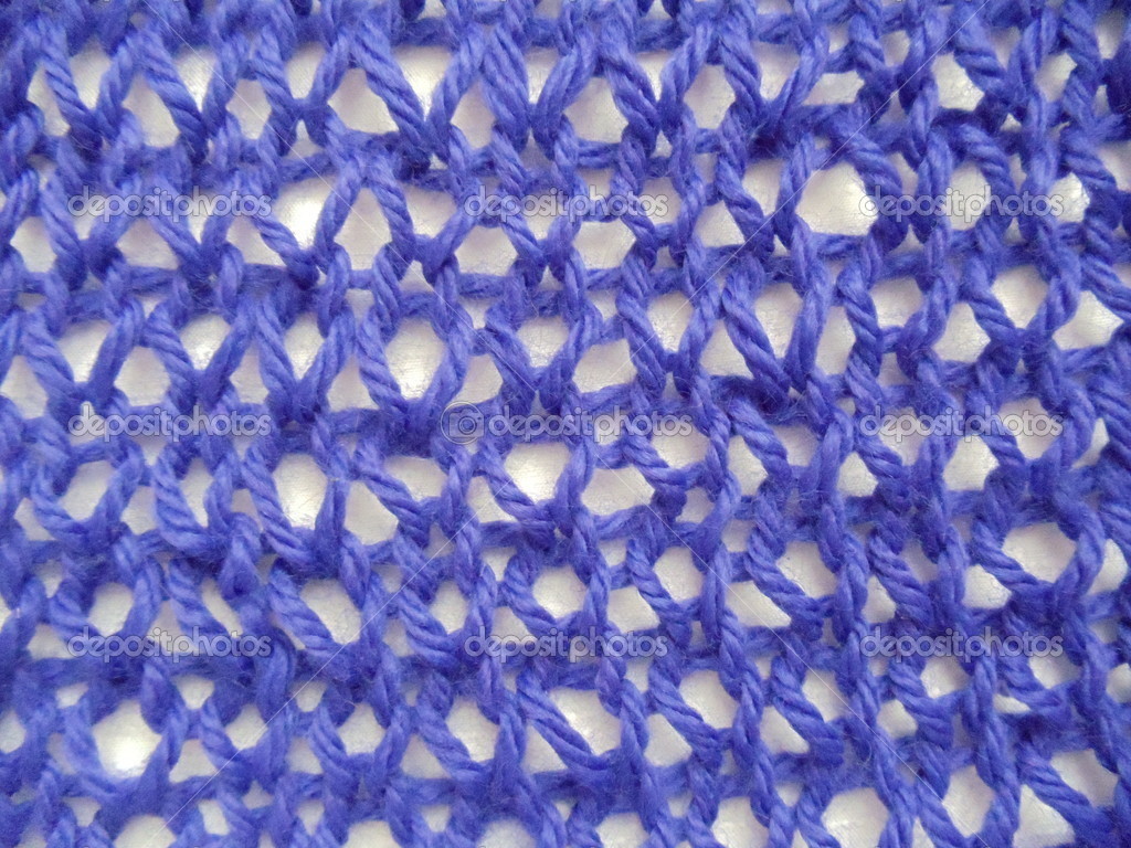 Close-up. A blue handmade knitted woolen fabric with a seamless fishnet ...