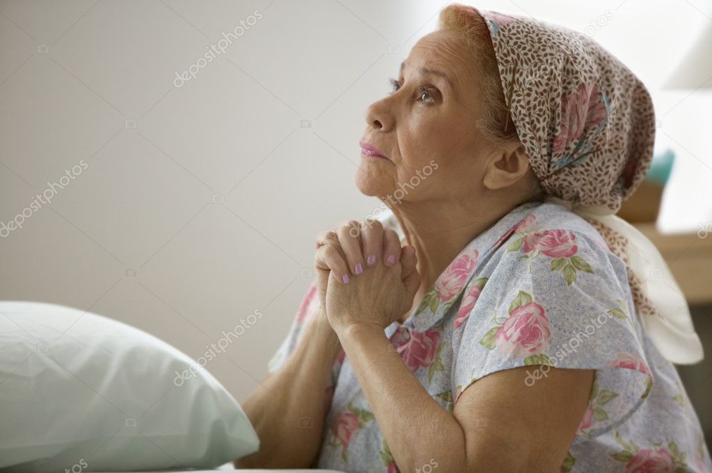 Elderly woman praying before bed — Stock Photo © bst2012 #23232700