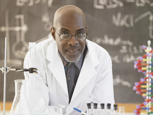 African male science teacher in front of the blackboard - Stock Image ...