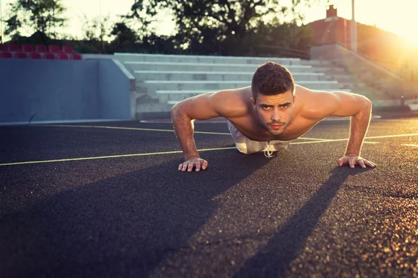 Handsome shirtless young man doing pushups on sunny day - Stock Image - Everypixel