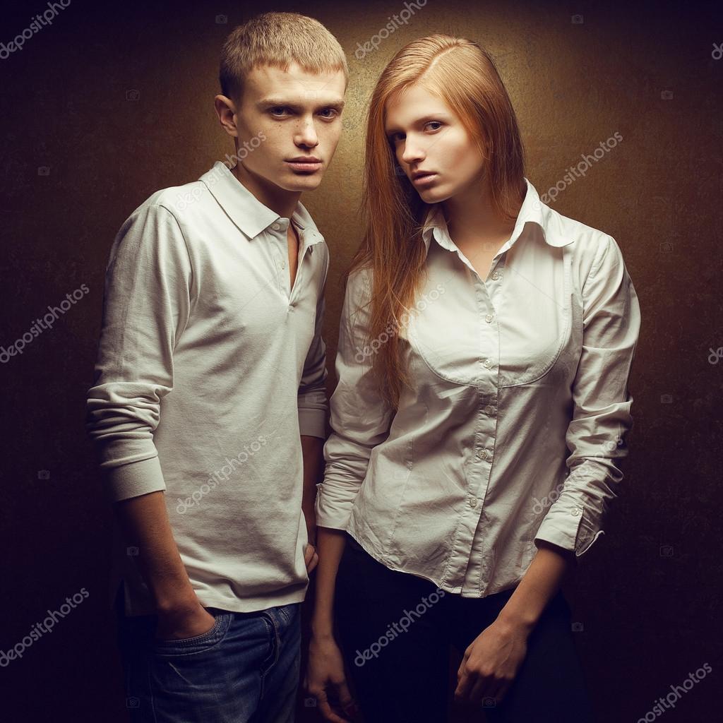 Portrait of two gorgeous red-haired (ginger) fashion twins in wh ...