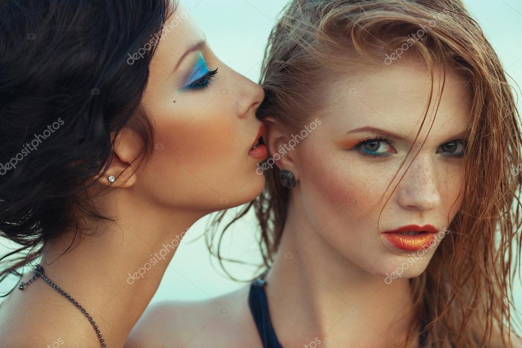 Beautiful couple of models with perfect arty make-up on the beac ...