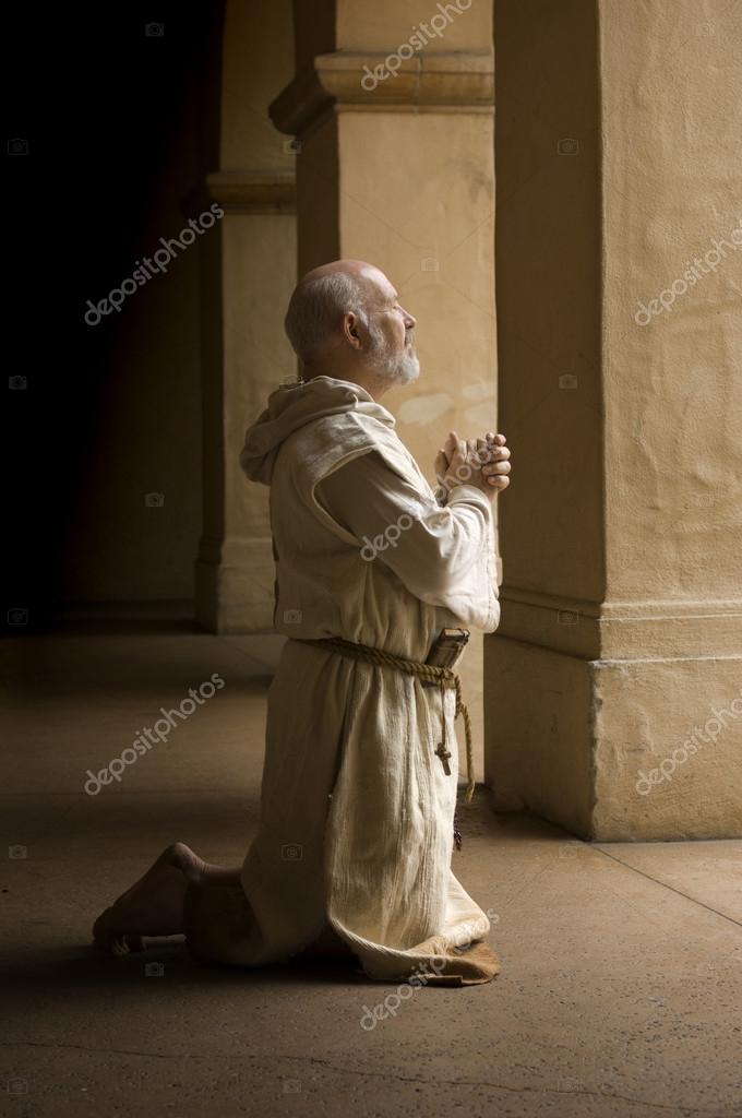 Priest Praying On Knees