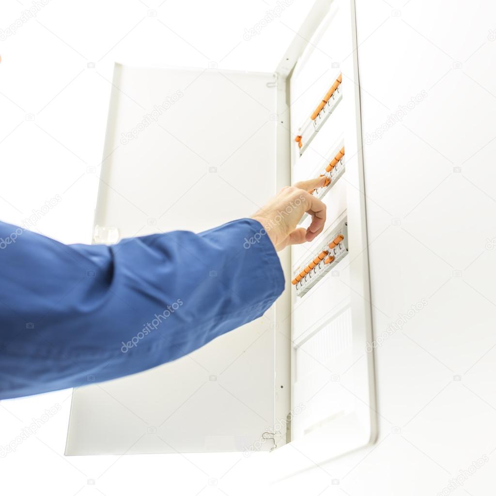 Man checking the electrical fuse box Stock Photo by ©Gajus-Images 39184177