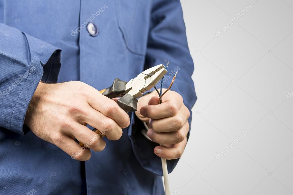 Electrician repairing an electrical cable — Stock Photo © Gajus-Images ...